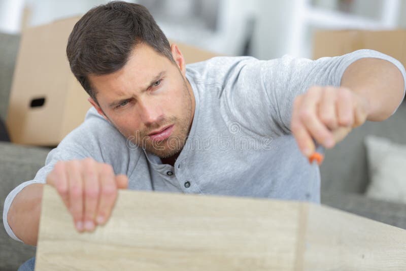 Man Having Hard Time Assembling Furniture Stock Photo - Image of ...