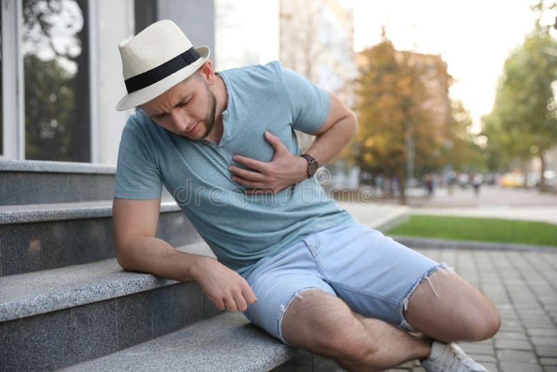 Man Having Heart Attack on City Street Stock Photo - Image of heart ...
