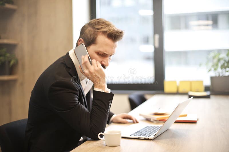 Man Having A Phone Call In-front Of A Laptop Stock Image - Image of ...