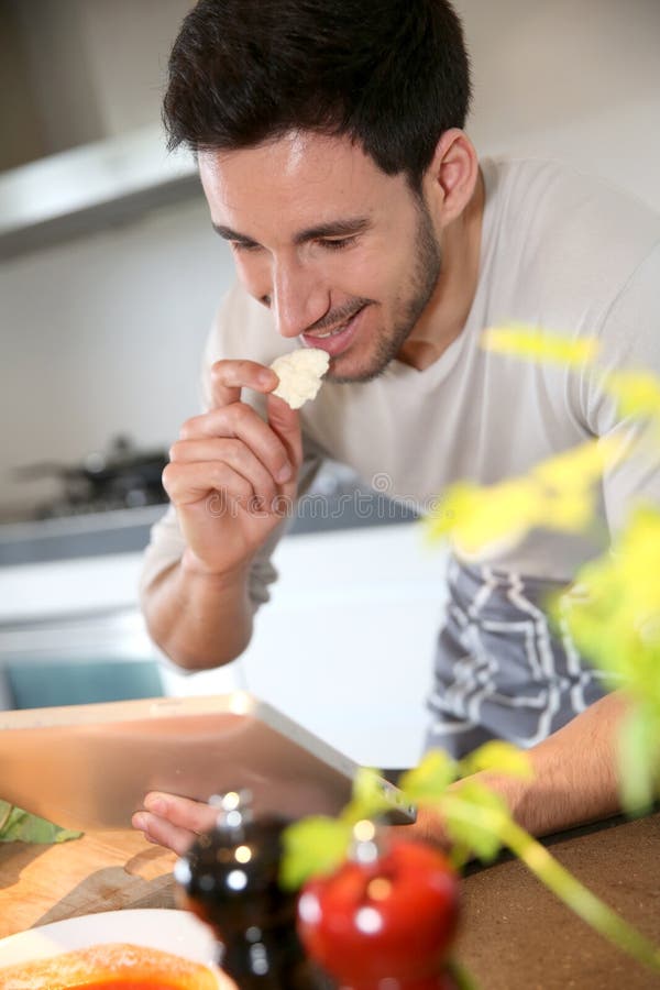 Man Having a Snack while Cooking Stock Image - Image of cooking ...