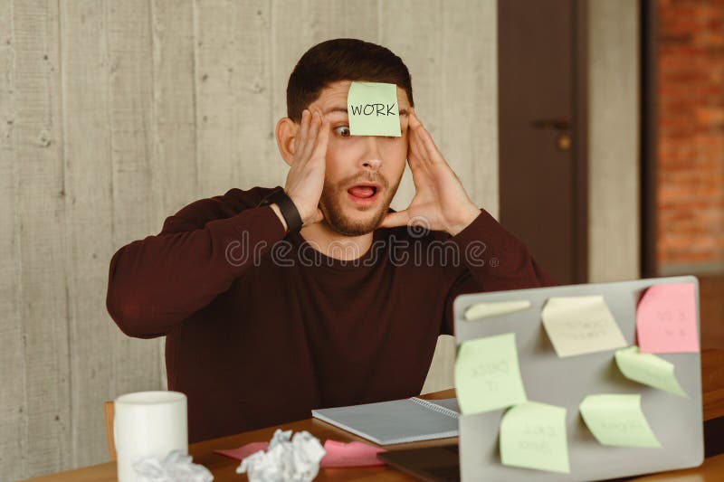 Man Having Sticky Notes Everywhere Sitting at Laptop in Office Stock ...