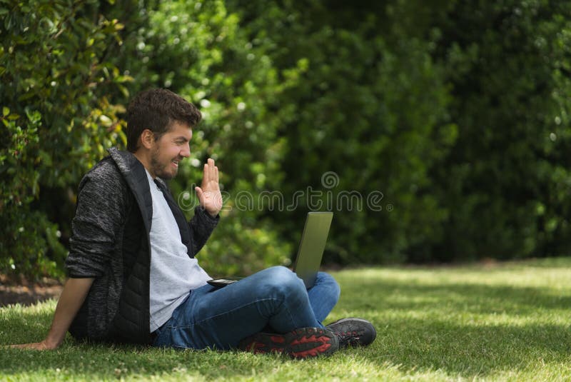 Man Having a Video Call with His Computer Saying Hello through the ...