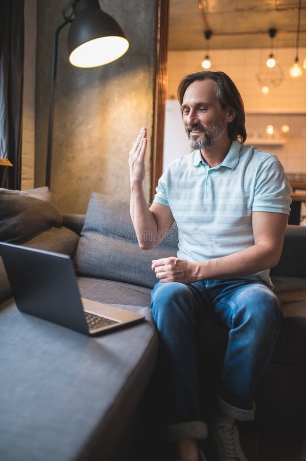 A Man Having a Video Call and Using Fingers Language Stock Photo ...