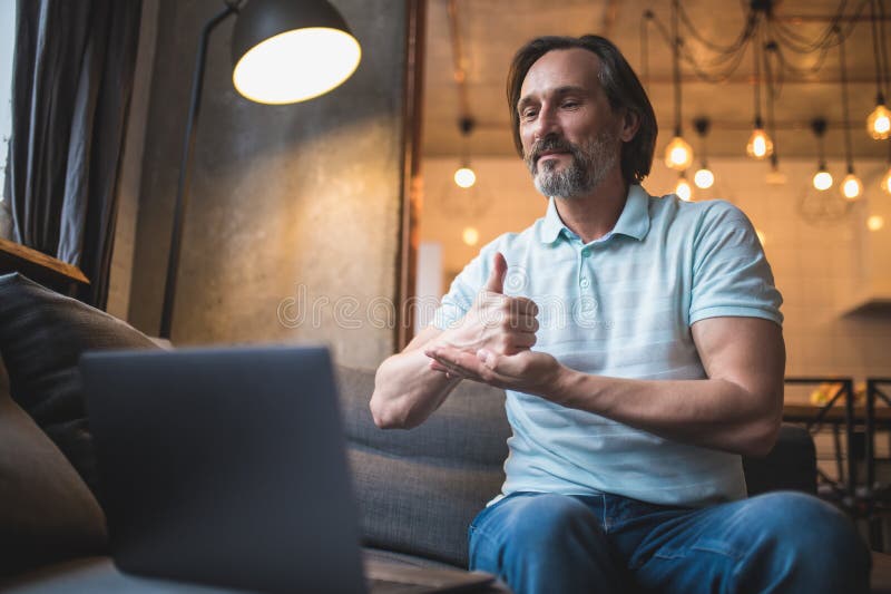 A Man Having a Video Call and Using Fingers Language Stock Image ...