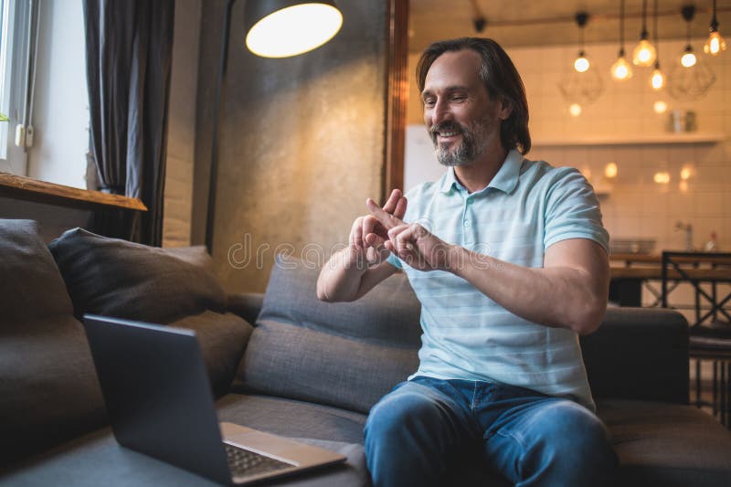 A Man Having a Video Call and Using Fingers for Sign Language Stock ...