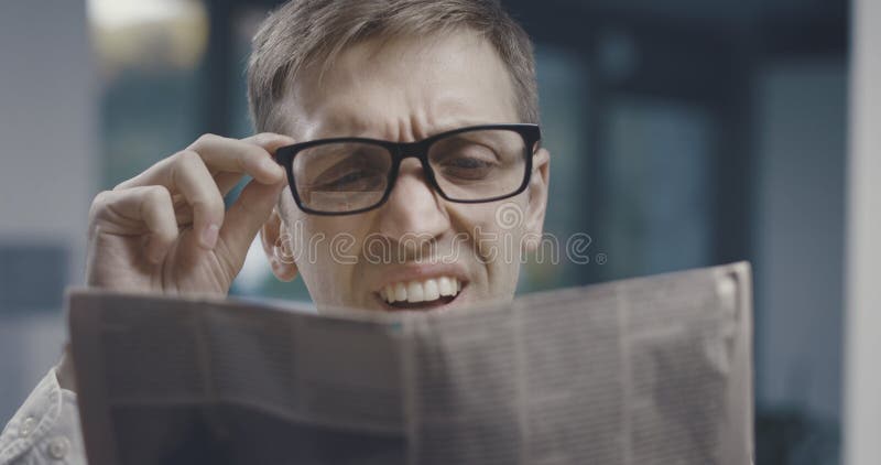 Man Having a Vision Problem while Reading a Newspaper Stock Photo ...
