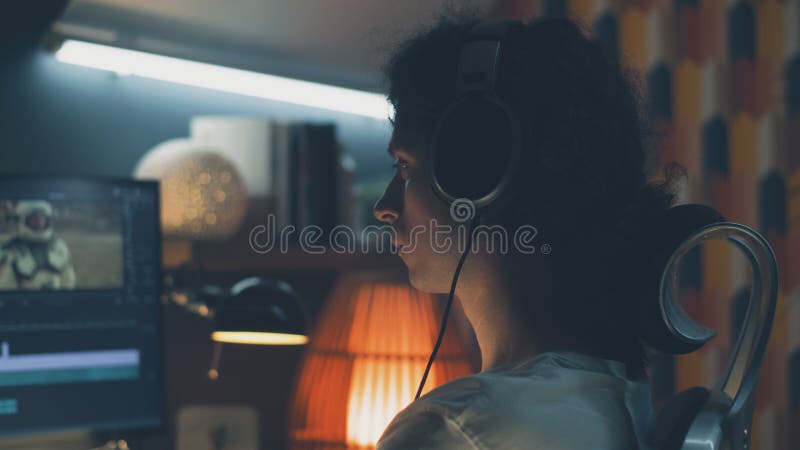Man in Headphones Editing Video on Pc Stock Image - Image of night ...