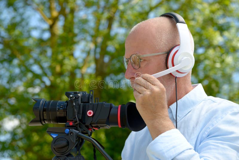 Man with Headphones, Using a Camera Dslr Stock Photo - Image of taking ...