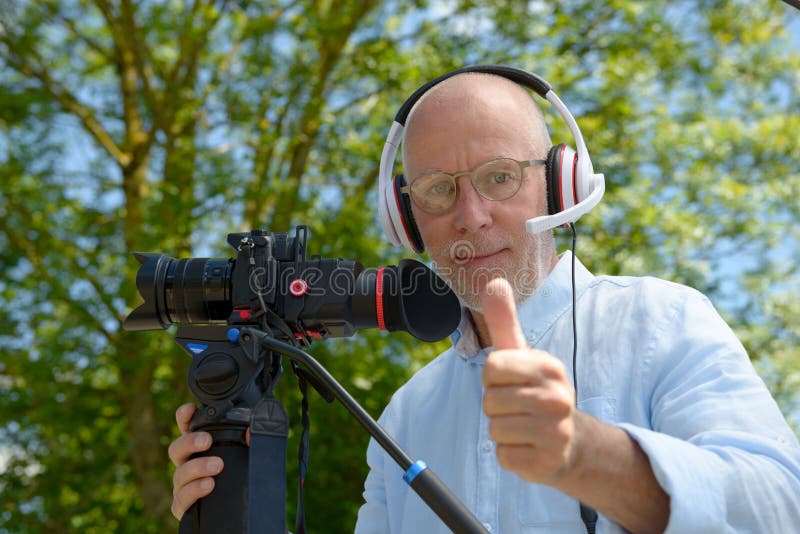 Man with Headphones, Using a Camera Dslr Stock Image - Image of ...