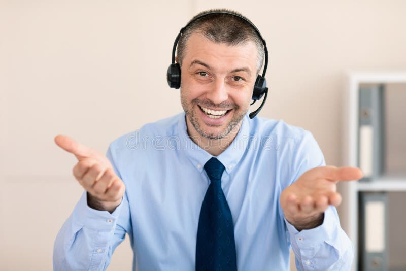 Man in Headset Smiling Sitting in Customer Support Office Stock Photo ...