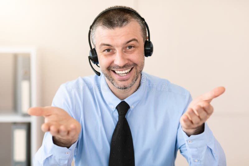 Man in Headset Smiling Sitting in Customer Support Office Stock Photo ...