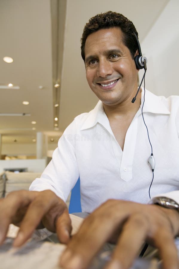 Man with Headset Working on Computer in Office Stock Photo - Image of ...