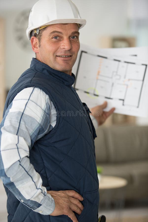 Man in Helmet with Blueprint Showing Plan on Site Stock Image - Image ...
