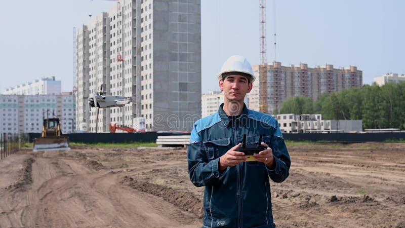 Construction Worker Controls a Drone in Front of a Modern House. the ...