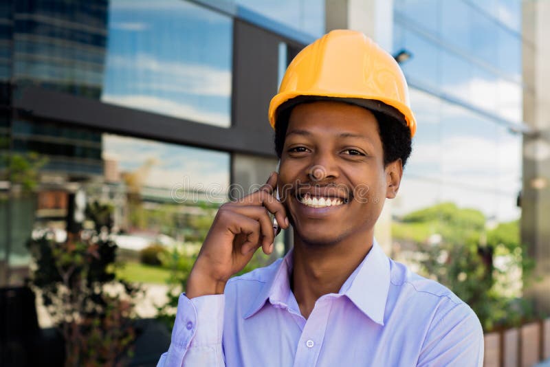 Man in Helmet Talking on the Phone Stock Photo - Image of indoors, male ...