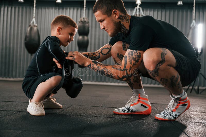 Man is Helping Kid with Learning and Practicing. Coach is Teaching the ...