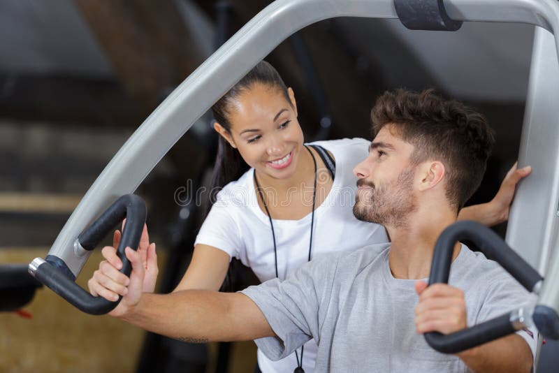 Man And Personal Trainer Discussing Training Plan In Gym Stock Photo ...