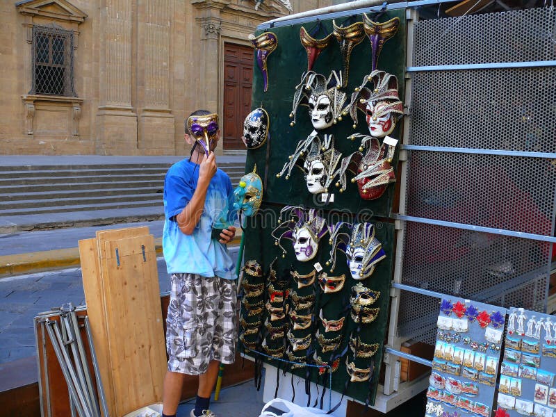 Man Trying on Venetian Masks at a Street Market in Florence Editorial ...