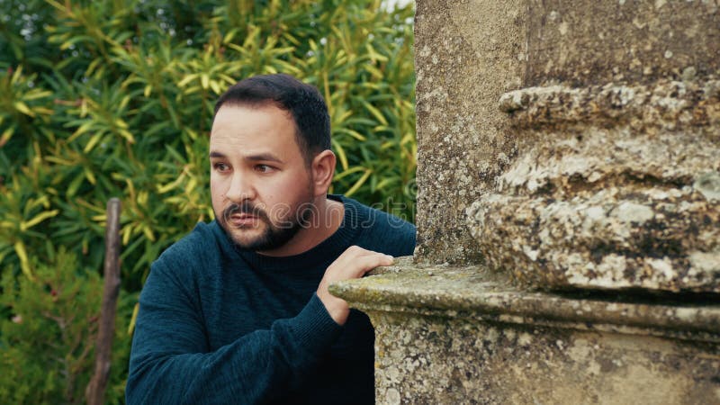 Man Hiding Behind a Column Looking Around Stock Footage - Video of ...