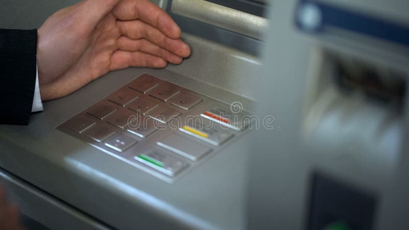 Man Hiding Keyboard of Automated Teller Machine while Inserting His Pin ...