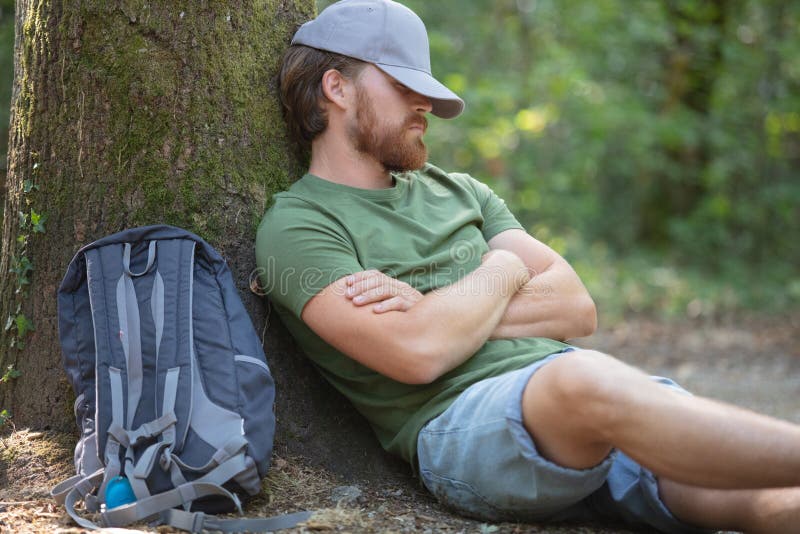 Man Hiker Taking Rest Sitting at Tree in Forest Stock Image - Image of ...