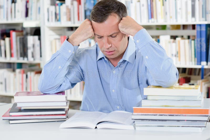 Man with books stock image. Image of library, degree - 173511225