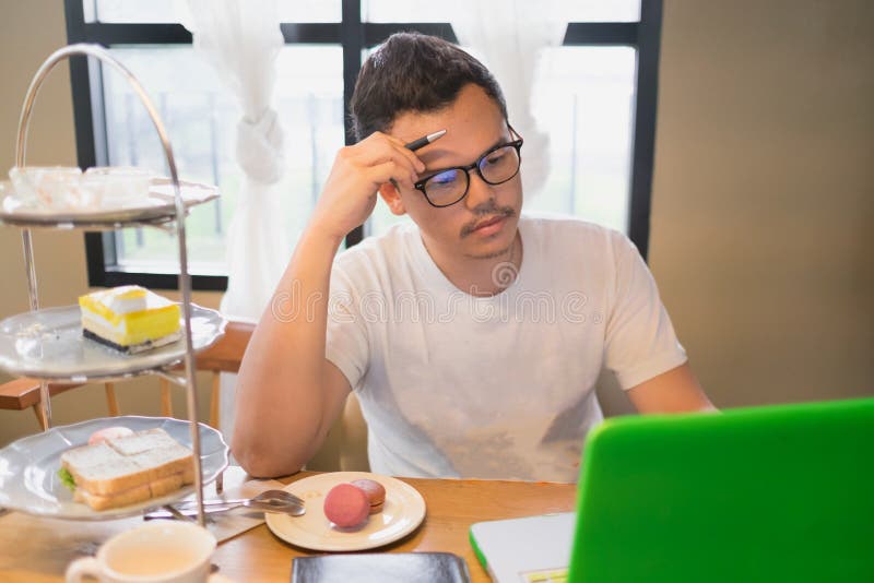 A Man and His Computer with Thinking Face at Tea Time Stock Photo ...