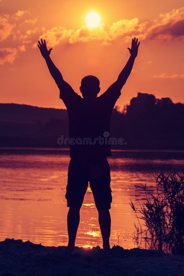 Man With His Hands Up At The Sunset On The Beach Stock Image - Image of ...