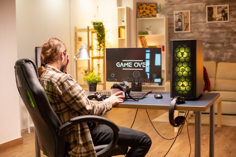 Man on His Powerful PC Computer in the Living Room Late at Night ...