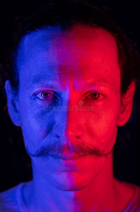 Man in His 30s Posing To the Camera with Blue and Red Lighting, Close ...