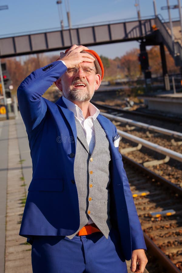 Man in His 50s Waiting at Train Station and Looking Angry Stock Photo ...