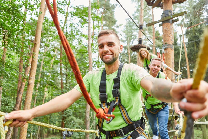 Man and His Team Climbing in the High Ropes Course Stock Image - Image ...