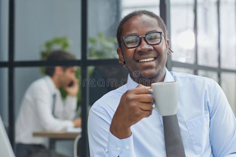 A Man at His Workplace at a Table in Front of a Computer Drinks Coffee ...