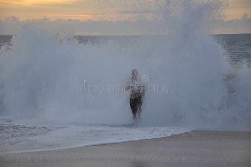 Man Hit by Big Wave on Papohaku Beach, Molokai Stock Image - Image of ...