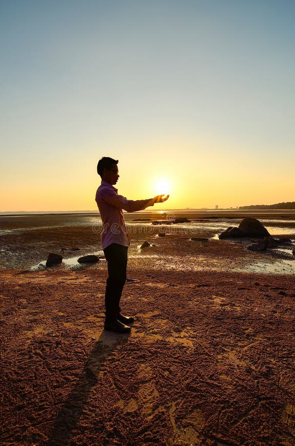 Man Hold the Sun Using His Hand Stock Image - Image of body, sunset ...