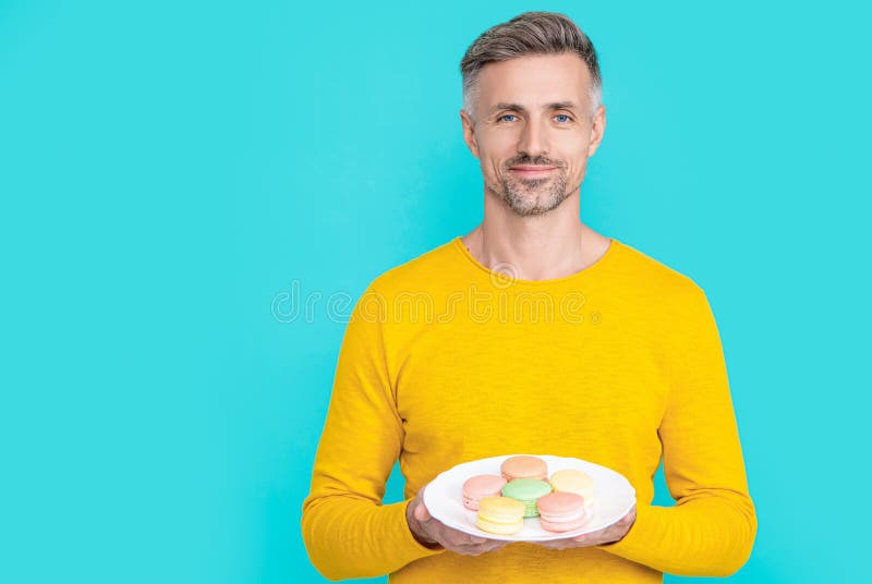 Man Hold Yummy Macaroon Isolated on Blue, Copy Space. Man Hold Yummy ...