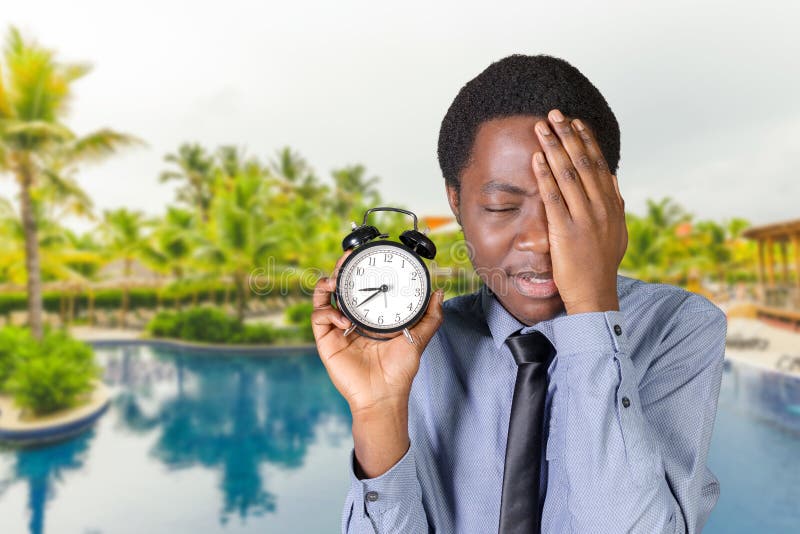 Man holding an alarm clock stock image. Image of clock - 69703399