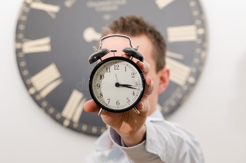 Man holding alarm clock stock image. Image of concept - 64039033