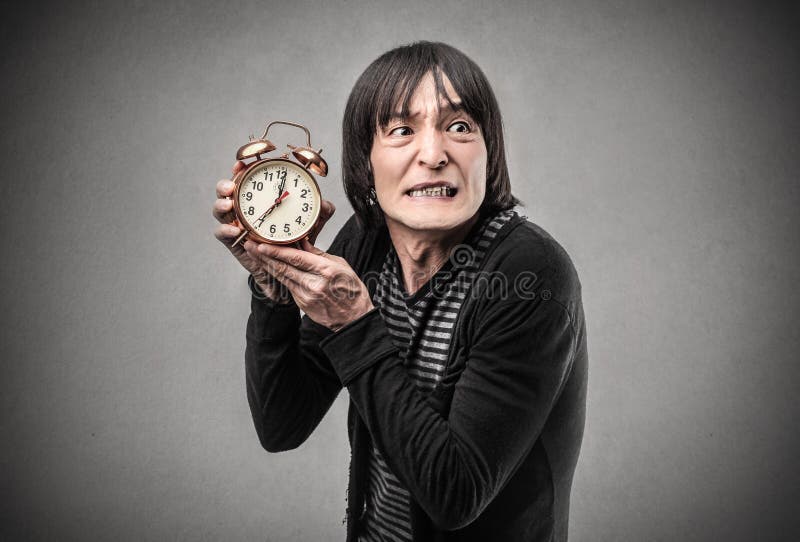 Man holding an alarm clock stock image. Image of tired - 35824001