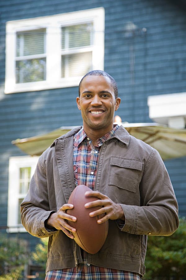 Man Holding an American Football Stock Image - Image of holiday, family ...