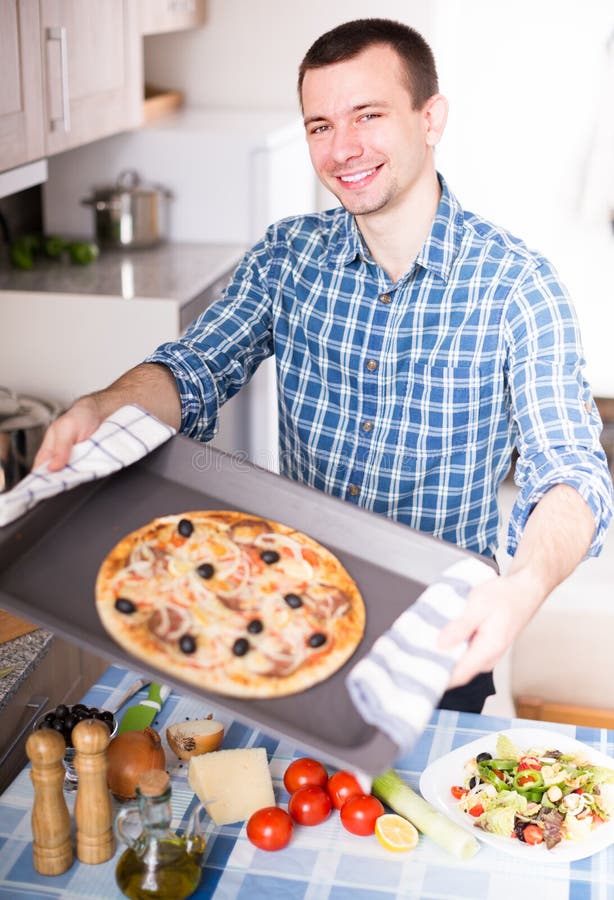 Man Holding Baking Sheet with Delicious Pizza Stock Photo - Image of ...