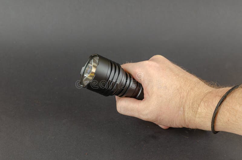 A Man is Holding a Black LED Hand Flashlight Stock Image - Image of ...