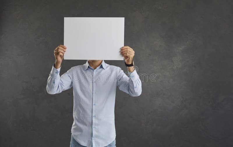 Man Holding Blank White Sheet of Paper in Front of His Face Showing ...
