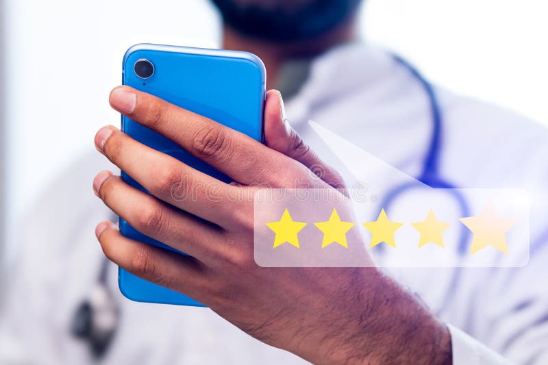 A Man Holding a Blue Cell Phone with a Star Rating on the Screen Stock ...