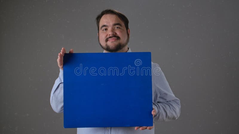 Man Holding Blue Signboard Against Gray Background Stock Photo - Image ...