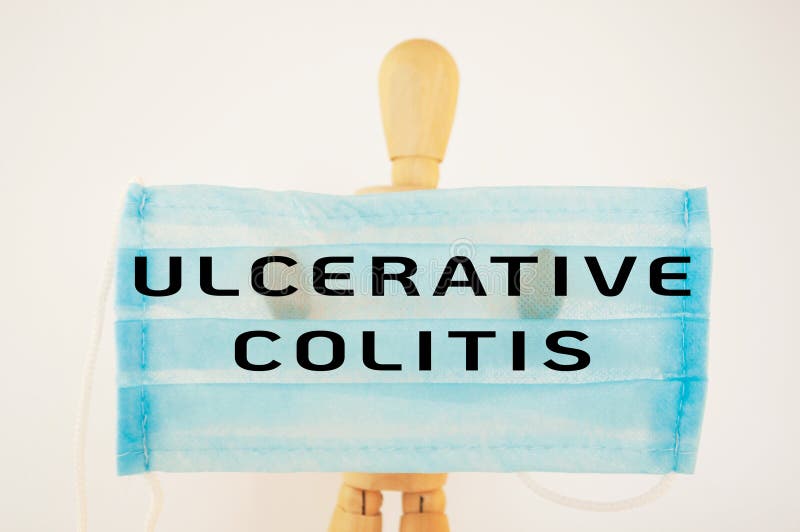 Man is Holding a Blue Surgical Mask with the Words Ulcerative Colitis ...