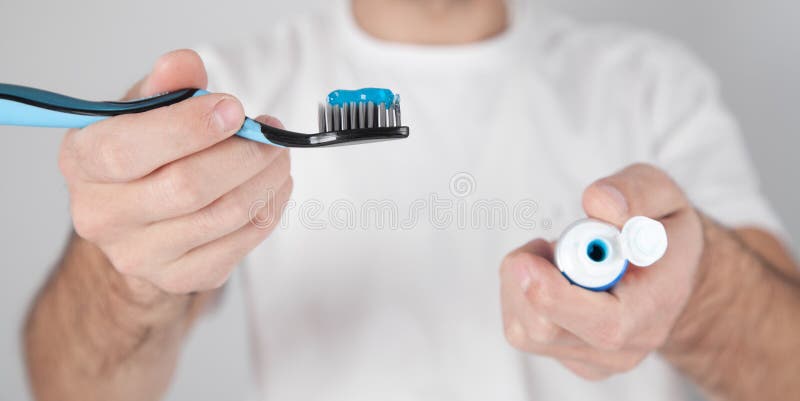 Man Holding Blue Toothpaste and Toothbrush Stock Photo - Image of blue ...