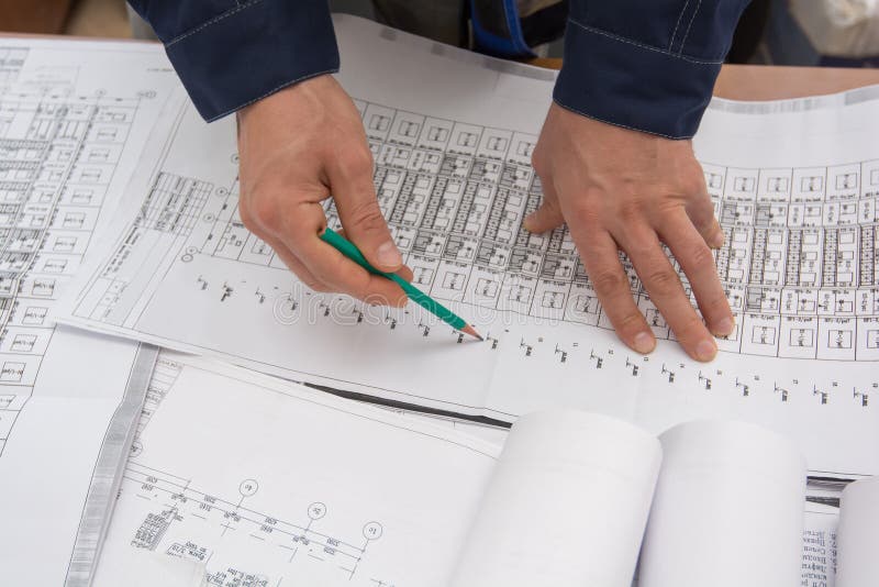 Man Holding Blueprints at Construction Site Stock Photo - Image of ...