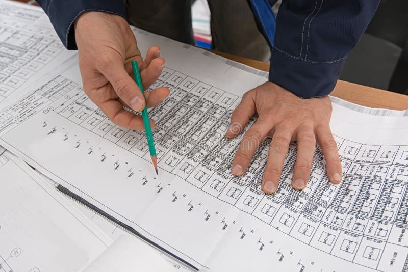 Man Holding Blueprints at Construction Site Stock Image - Image of ...