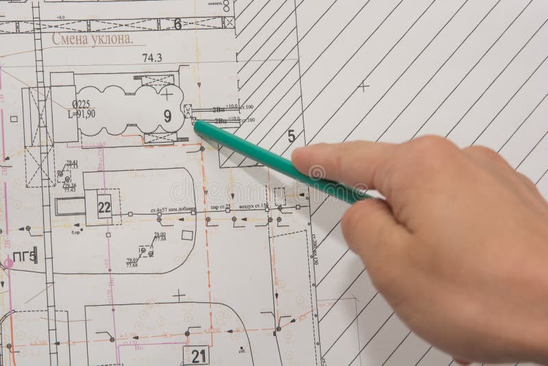 Man Holding Blueprints at Construction Site Stock Photo - Image of ...
